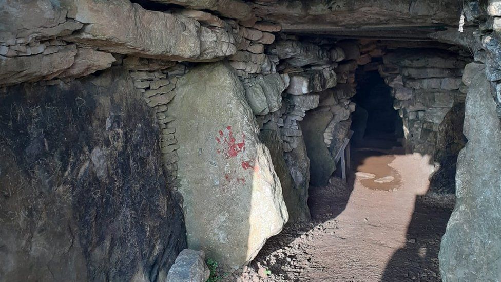 Stoney Littleton Long Barrow daubed in red handprints - BBC News
