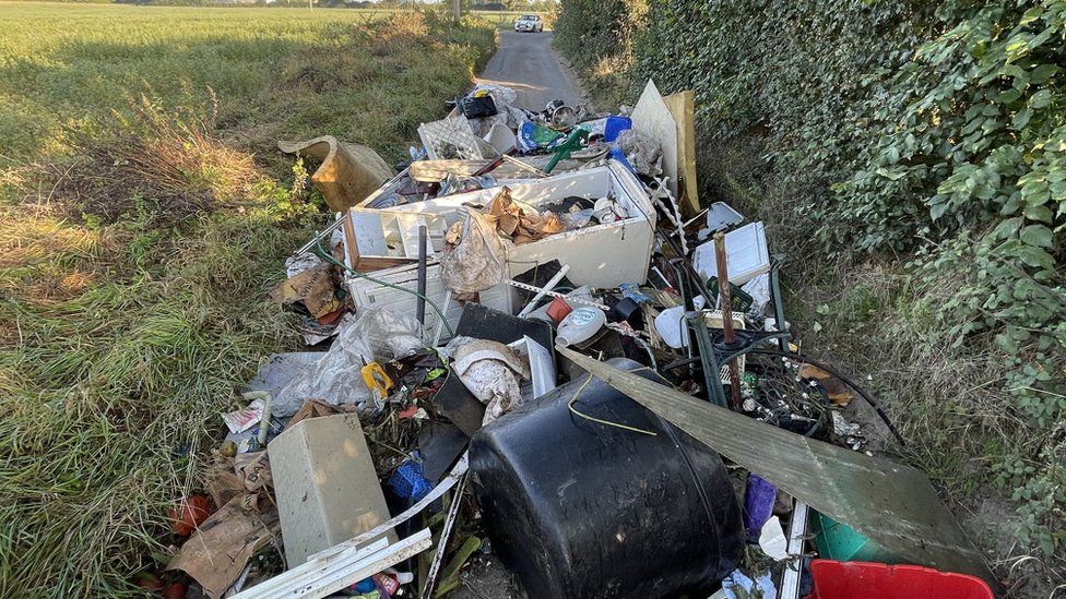Holton St Mary: Fly-tippers block road with dumped rubbish - BBC News