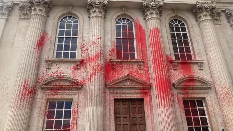 Cambridge university building sprayed with paint by protesters - BBC News