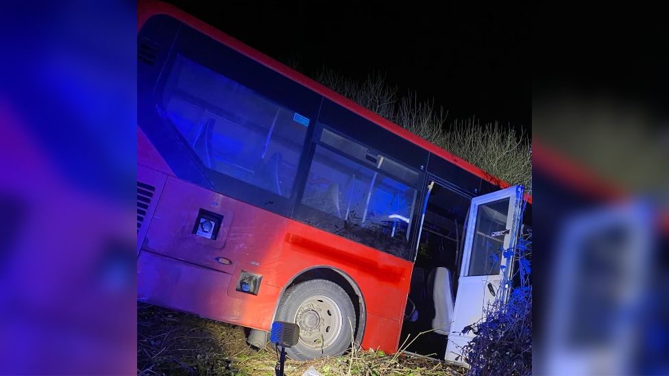 Paramedics treat four after bus comes off Cornwall road - BBC News