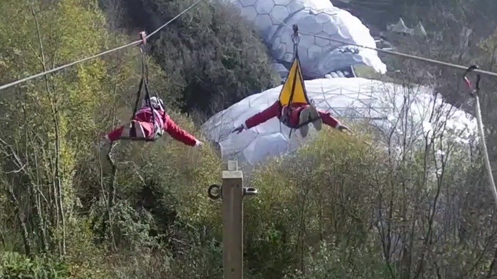 Derriford Hospital fundraisers take part in 'Santa Slide' - BBC News