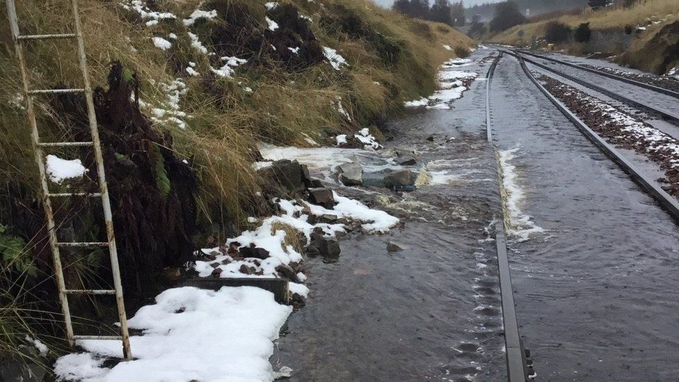 Flooding affects railway in Highlands and A75 in South - BBC News