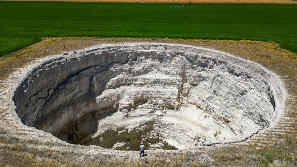 Nobody hurt in dramatic sink hole collapse on US football pitch - BBC ...
