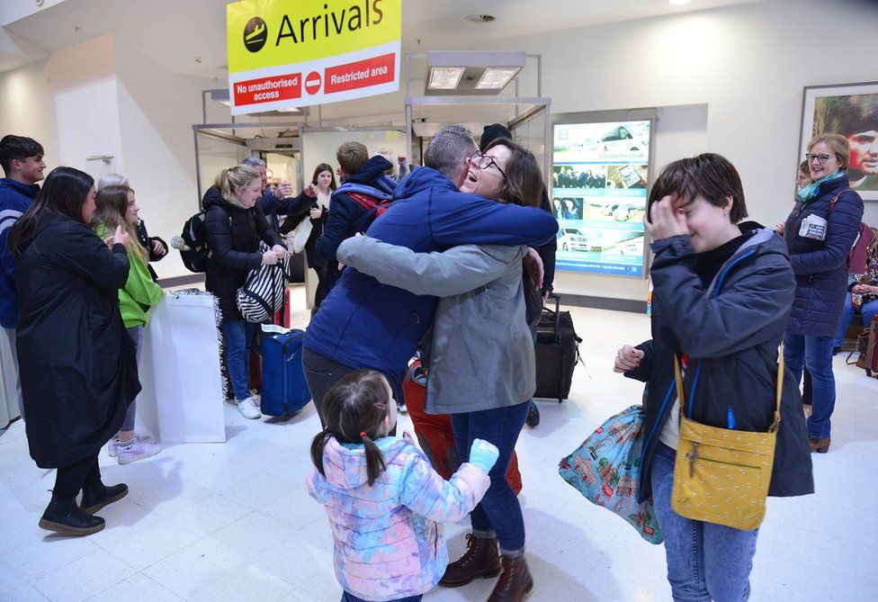 Christmas: Emotional family reunions at Belfast airports - BBC News