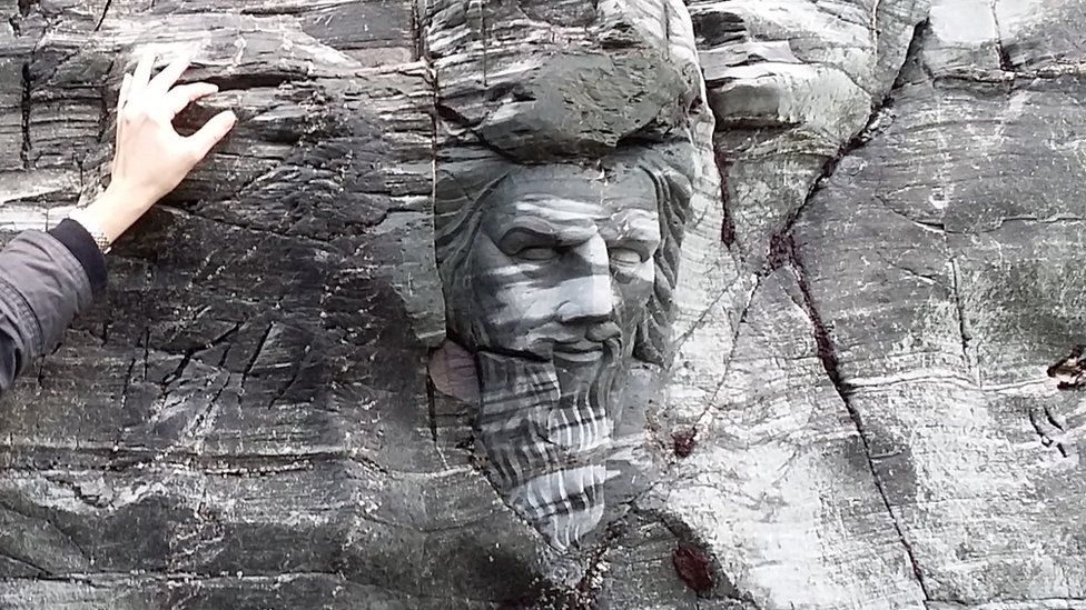 Tintagel Castle Merlin carving sparks 'Disneyfication' row - BBC News