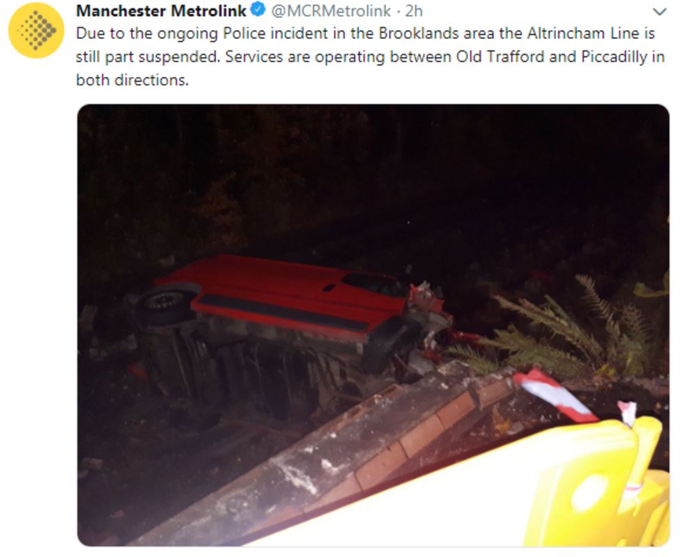 Two injured after van crashes on to Sale tram tracks - BBC News