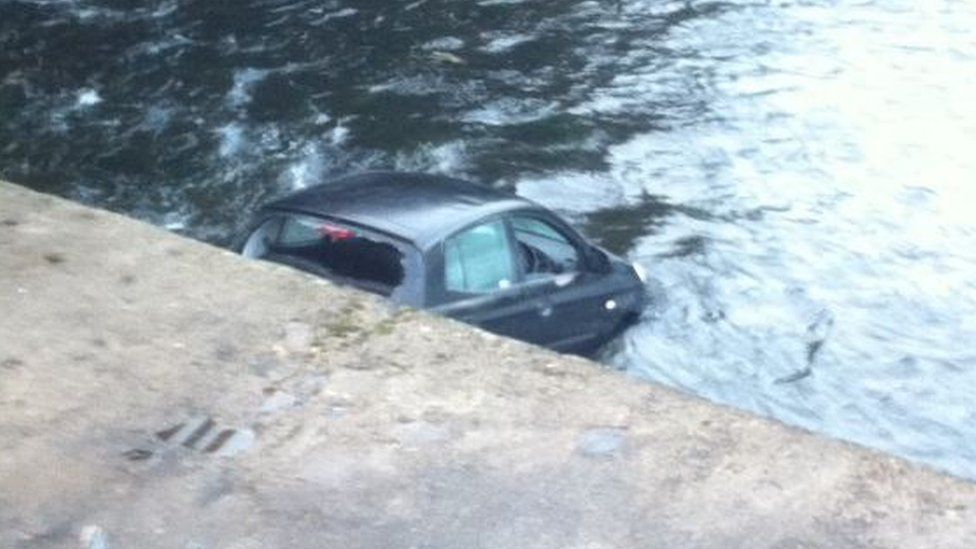 Three rescued from car stuck in river in lower Fishguard - BBC News