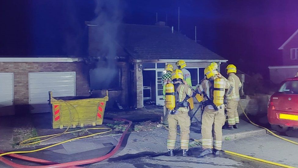 Weymouth woman and pet dog rescued from house fire - BBC News