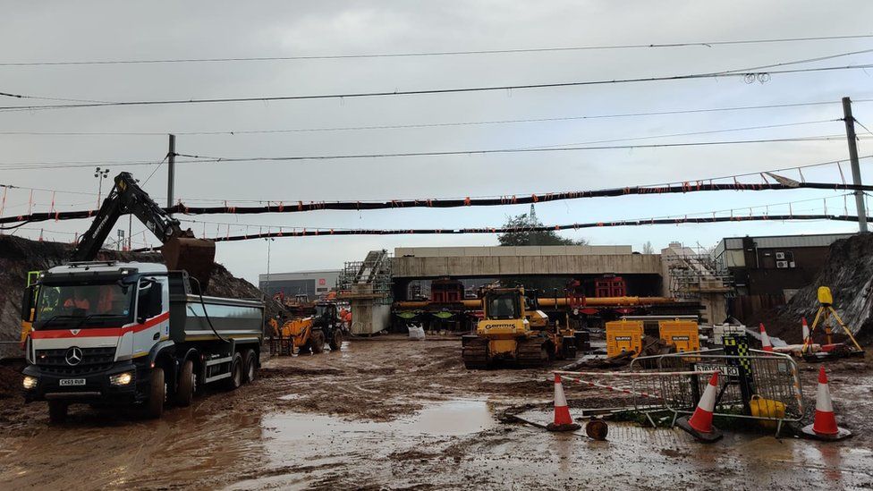 Lorries moving new railway bridge stuck in mud - BBC News