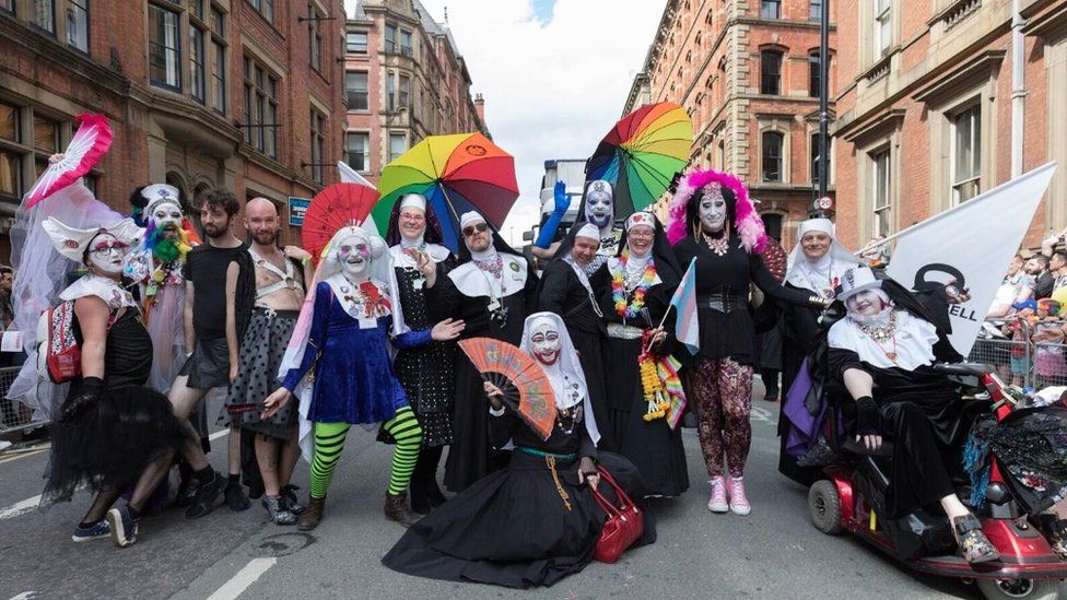 Manchester Pride: Thousands line streets for 'Graduation Parade' - BBC News