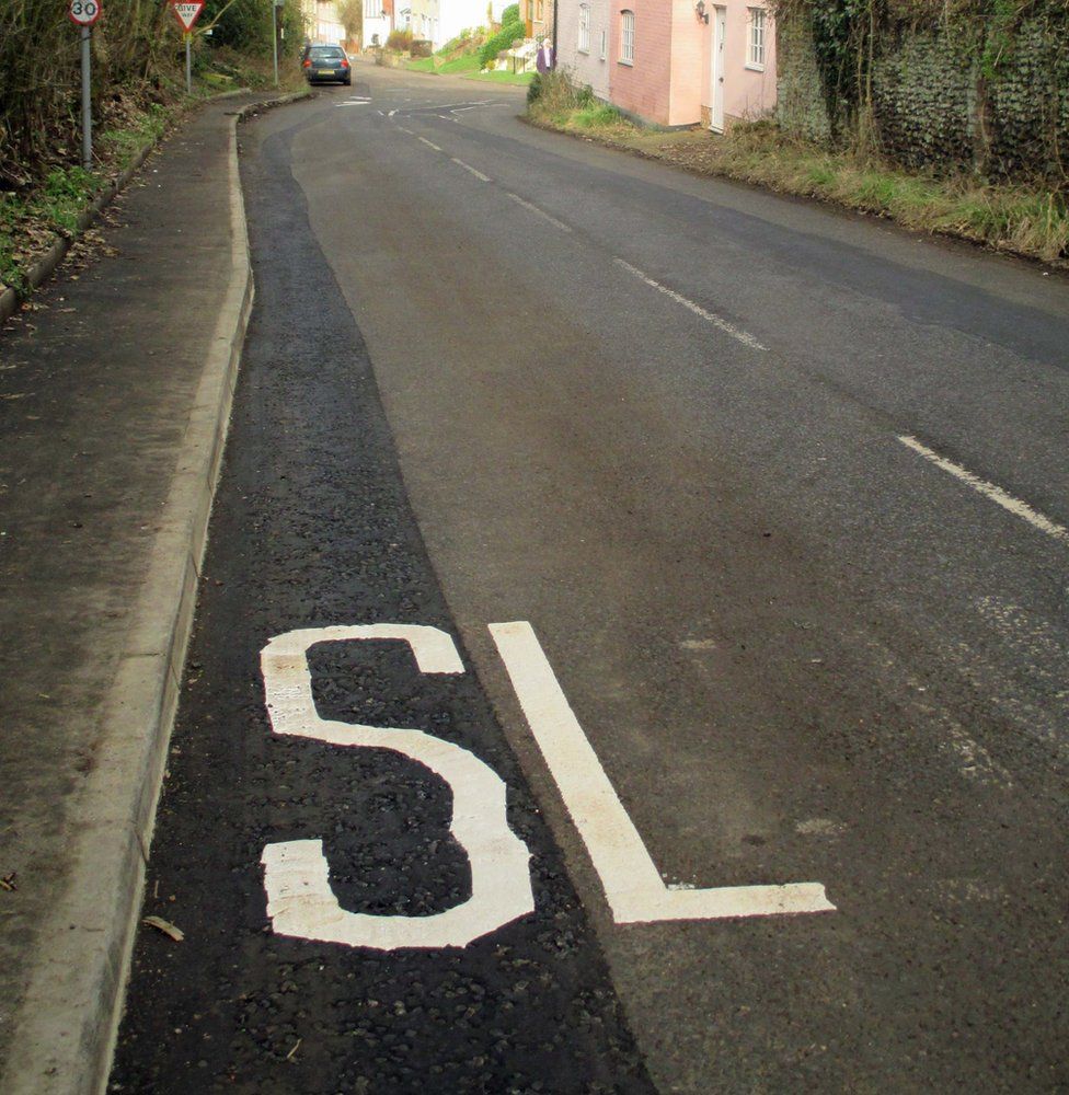 Half of word SLOW 'outside permitted area' on Boxford road - BBC News