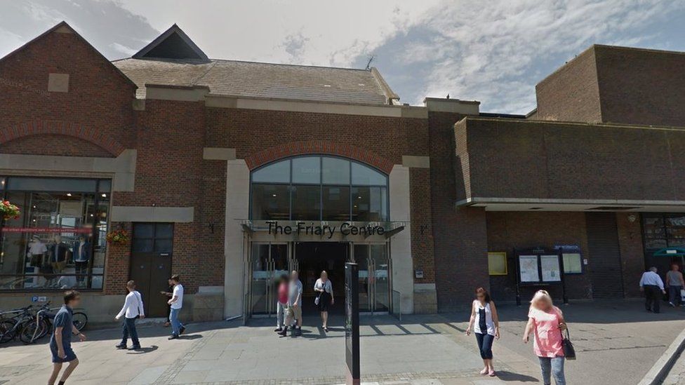 Guildford's Friary centre evacuated after car fires - BBC News