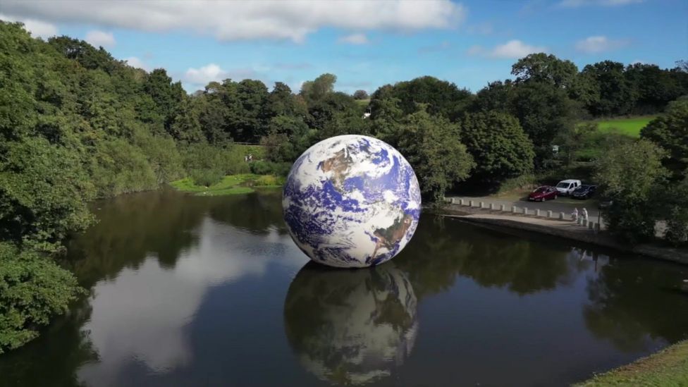 Giant Earth globe floating on Jersey reservoir - BBC News