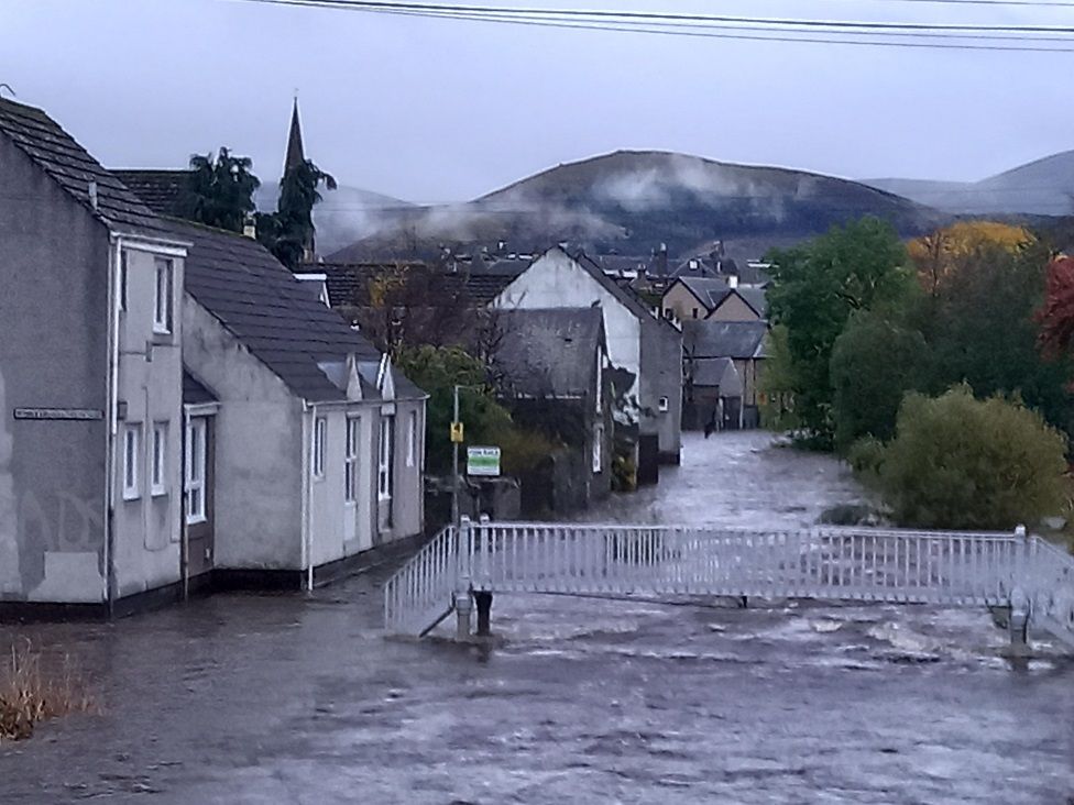 Two bridges 'washed away' by heavy downpours - BBC News