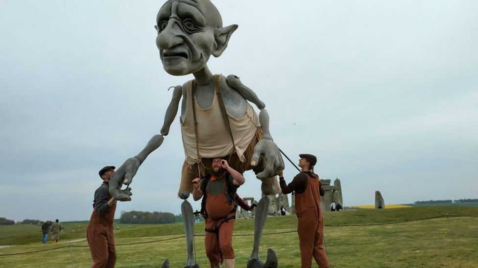 Gnomus, the giant puppet, entertains visitors at the ancient monument ...
