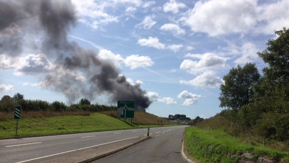 Fire crews put out large scrap yard fire in Pembrokeshire - BBC News