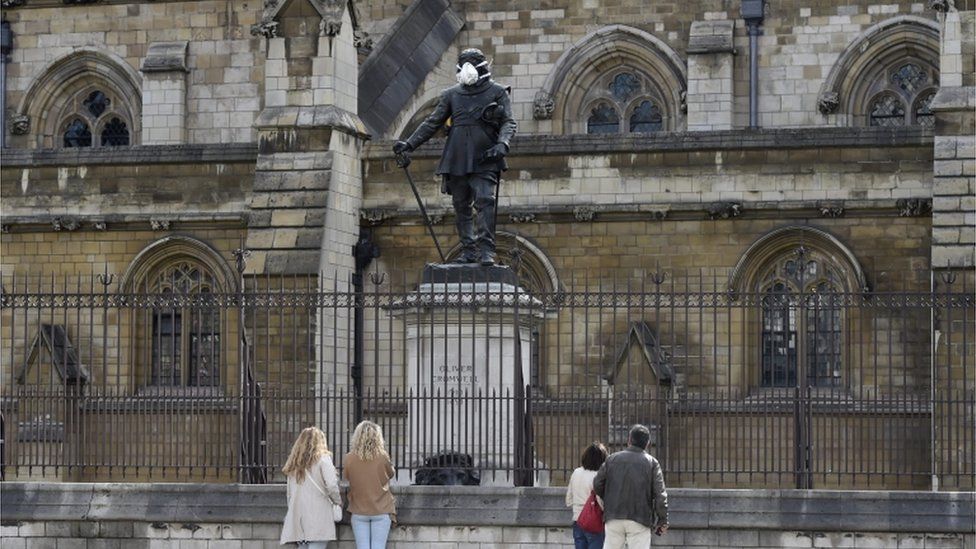 Eight arrests after Greenpeace protesters scale London monuments - BBC News