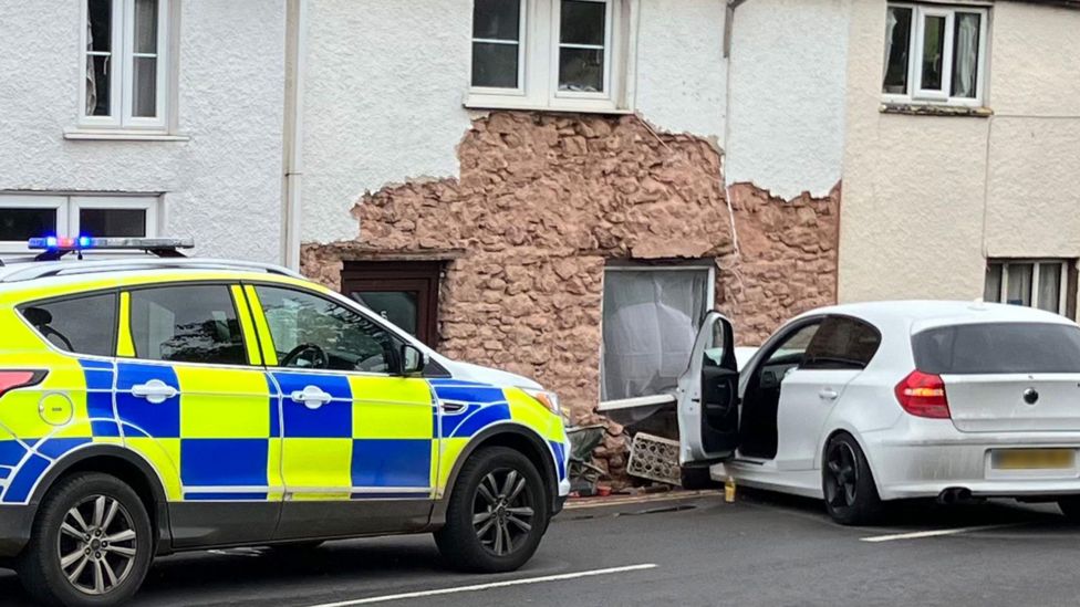 Somerset road partially blocked after car crashed into house - BBC News
