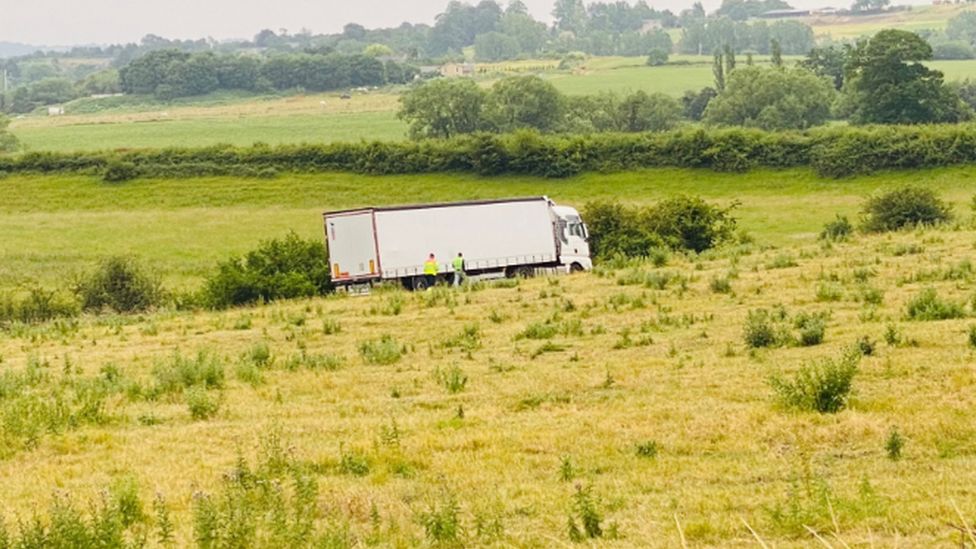Lorry ends up in field in Wiltshire as driver falls asleep - BBC News