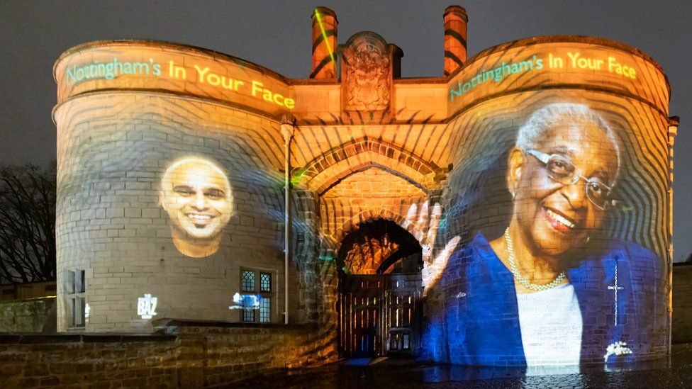 Nottingham Castle lights up walls with faces of residents - BBC News