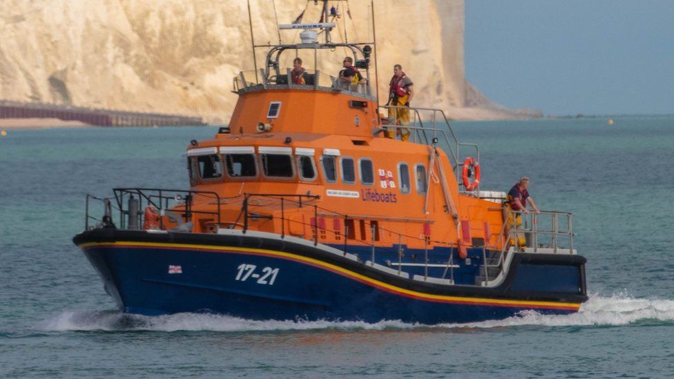 Royal Navy warship rescues five people on sinking yacht - BBC News