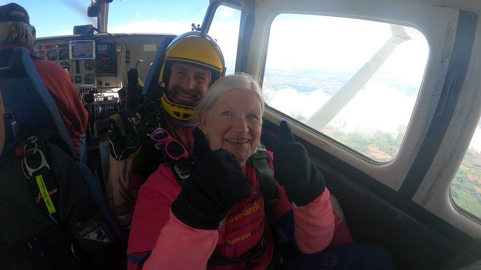 Stone woman with fear of heights does charity skydive - BBC News