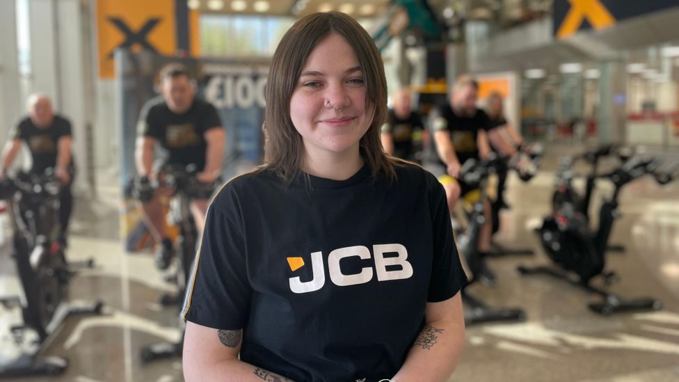 Staffordshire JCB cyclists finish 'around the world' challenge - BBC News