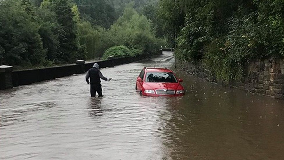 Flooding shuts roads and rail lines - BBC News