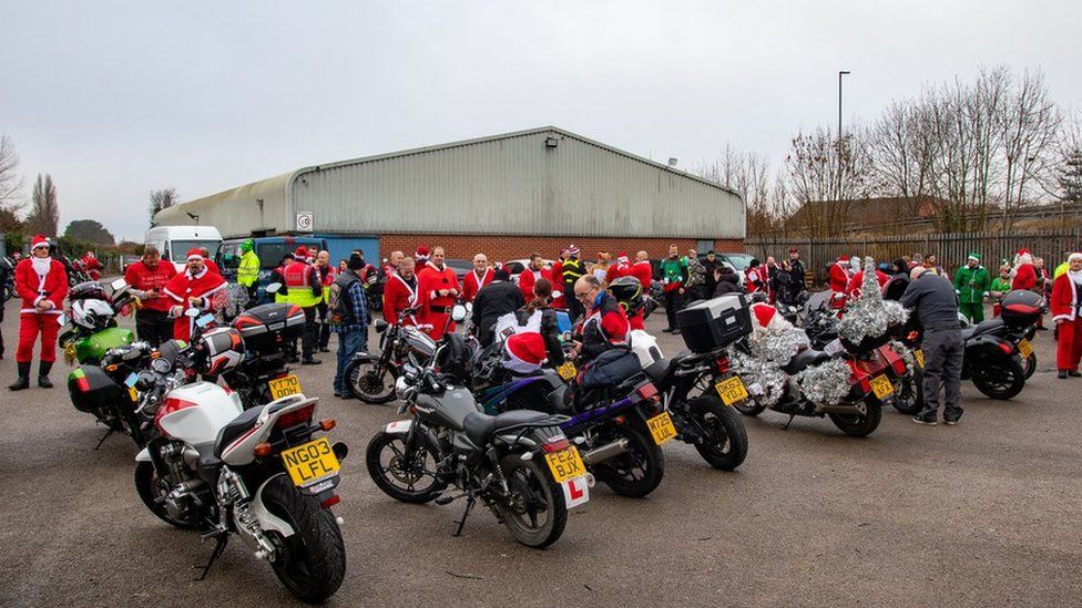 Bikers dressed as Santa drop off gifts for vulnerable children - BBC News
