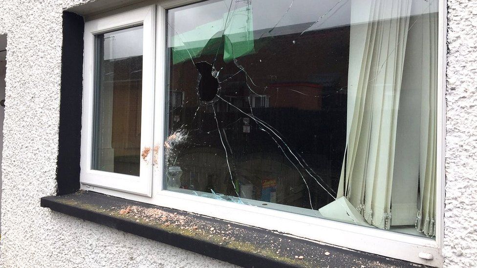 Brick lands in baby cot in Antrim 'hate crime attack' - BBC News