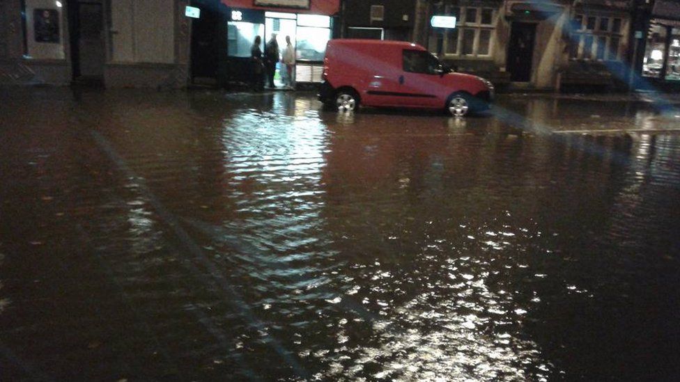 Two rescued after gravel washed down flooded Sleights hill - BBC News