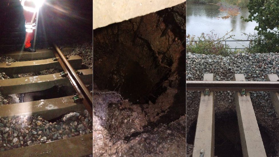Rail line repaired after floods leave 6ft hole under track - BBC News