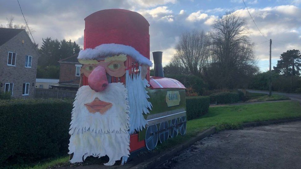 Rudolph the red phone box reindeer honours delivery drivers - BBC News