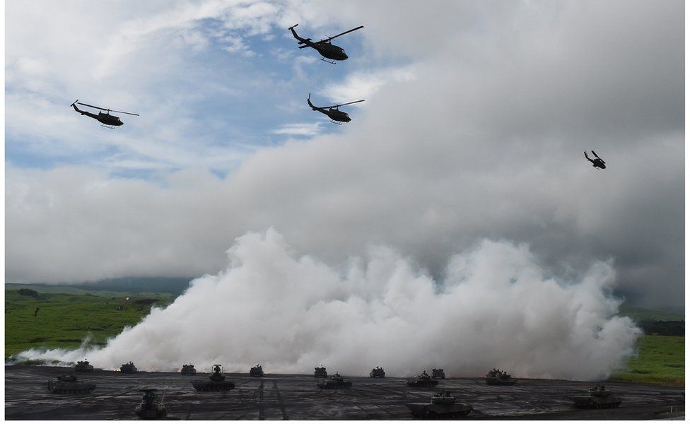 Japan's cabinet approves record boost in defence spending - BBC News