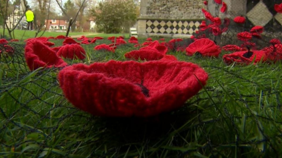 Knitted poppy cascade at Sudbury church honours war dead - BBC News