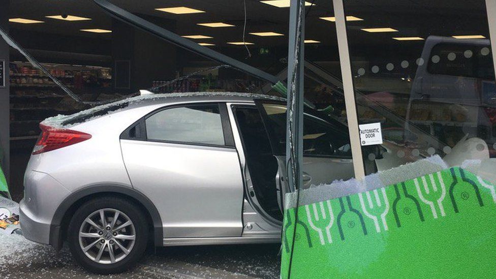 Car crashes into shop window in Belfast - BBC News
