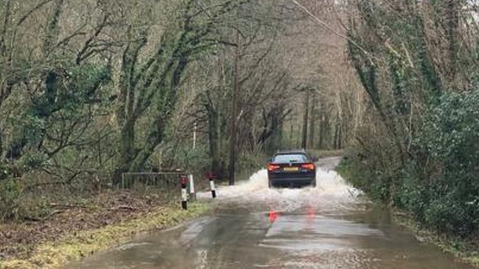 Wales weather: Footpath collapses into river amid flood warnings - BBC News