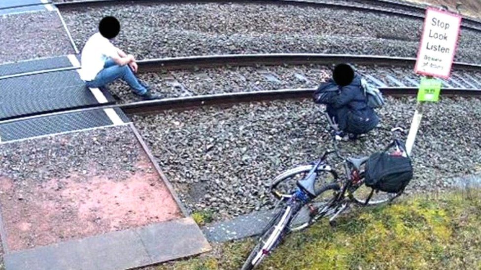 Pair taking picture on railway line 'risking their lives' - BBC News