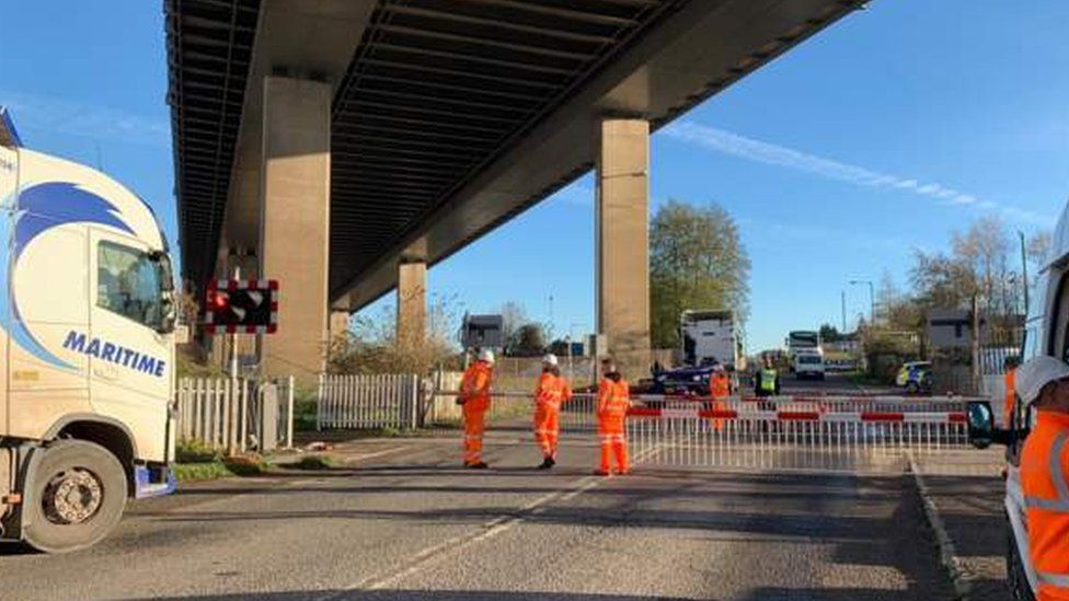 Barrier ripped off as lorry hits level crossing - BBC News