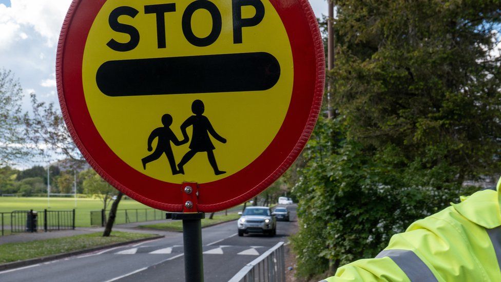Lollipop crossing patrol staff recruitment frozen in NI - BBC News