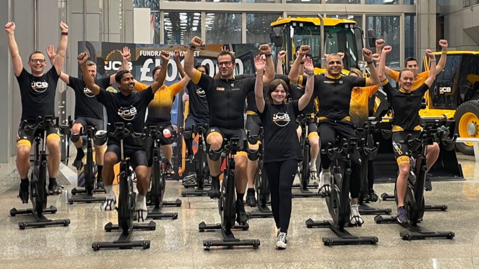Staffordshire JCB staff cycle 'around world' to help woman with cancer ...