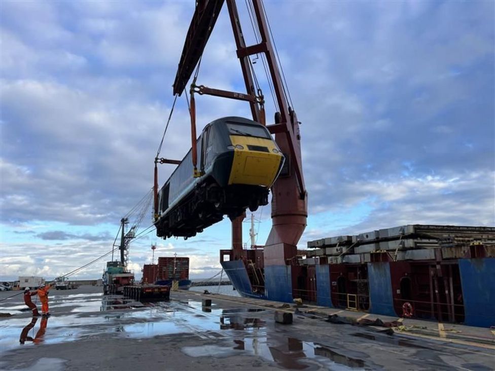 Retired train carriages set sail for new life abroad - BBC News