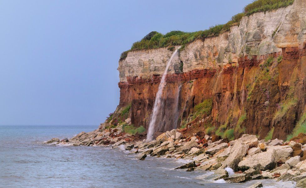 Hunstanton clifftop waterfall photographed after storm - BBC News