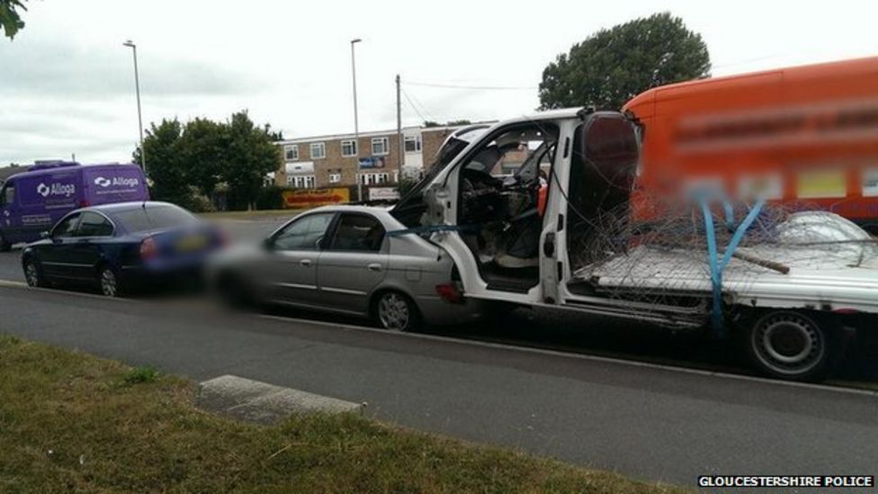 Gloucester driver caught towing van-strapped-in-car-boot - BBC News