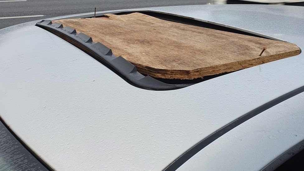 Car driven with wooden plank nailed to sunroof on M25 in Hertfordshire ...