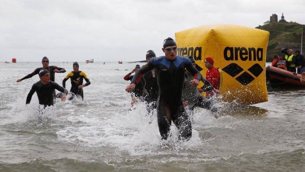 Thousands take part in Ironman Wales event in Tenby - BBC News
