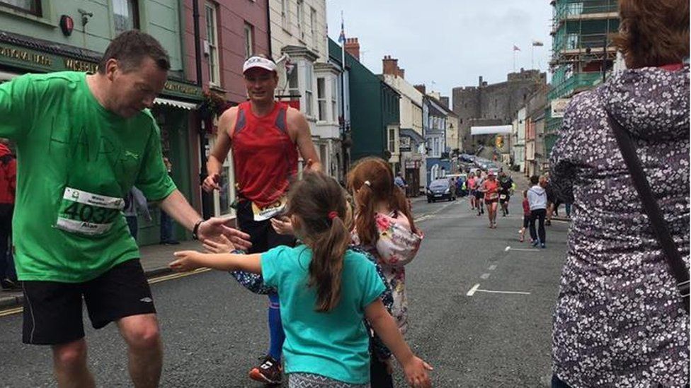 Thousands cheer on Long Course Weekend triathletes in Tenby - BBC News