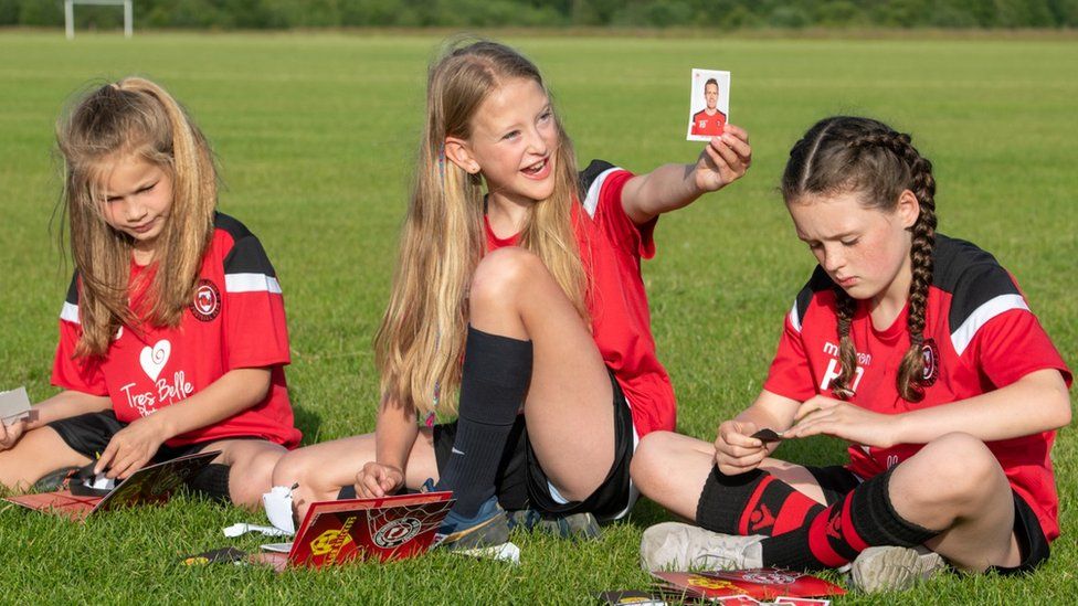 Dad makes sticker album for daughter's Rothwell football team - BBC News