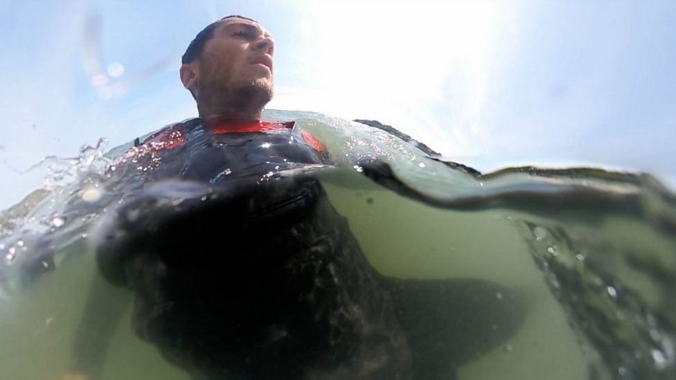 RNLI lifeguards reunite with boy they saved from rip in Cornwall - BBC News