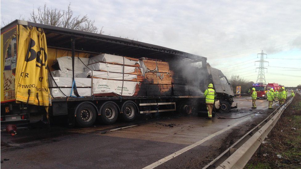 Wood lorry blaze closes both sides of A12 - BBC News